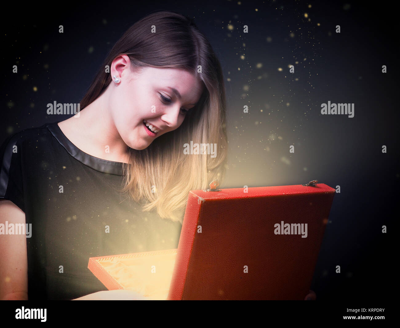 Beautiful young woman with a magical gift box Stock Photo - Alamy