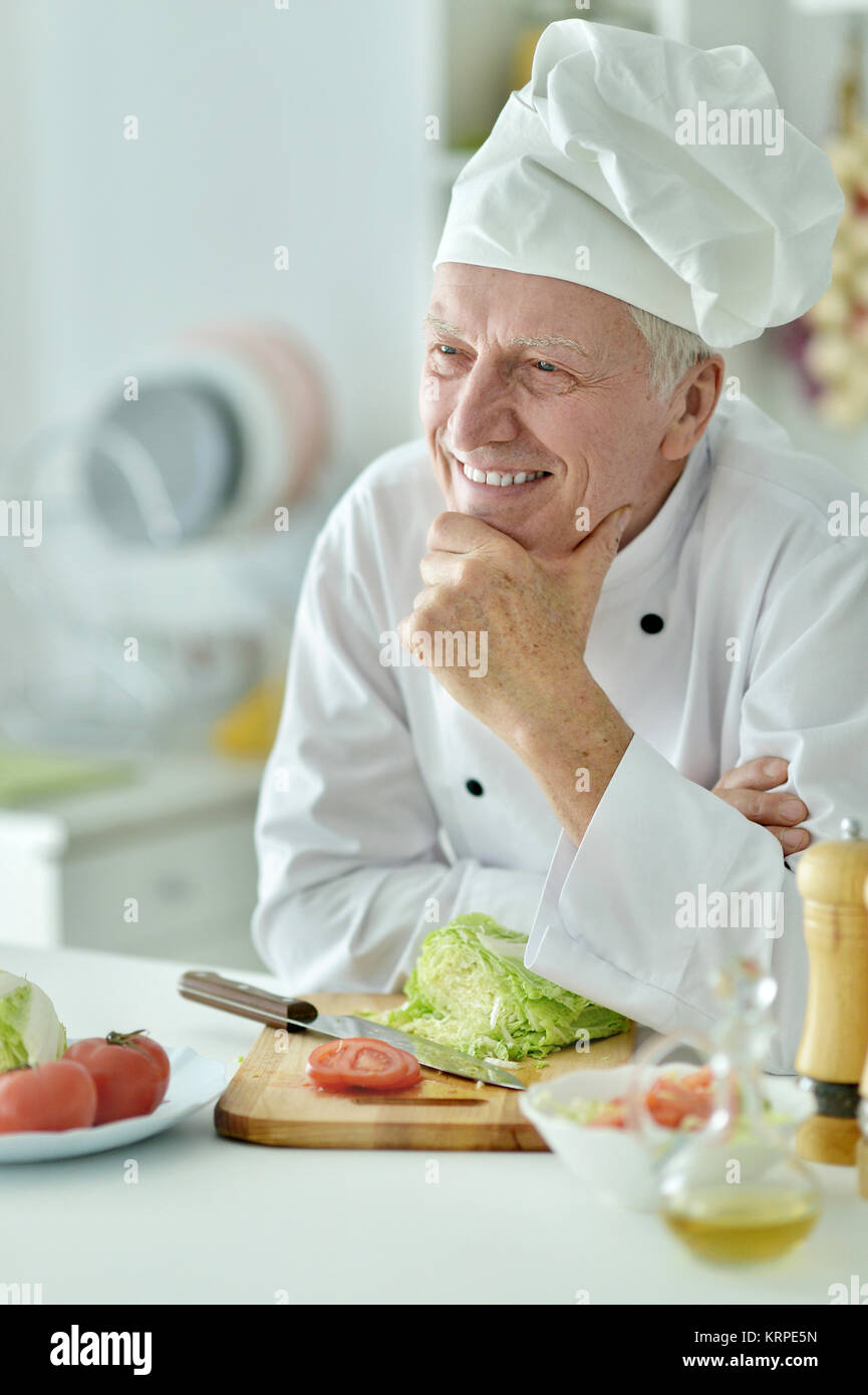 elderly male chef cooking salad Stock Photo - Alamy