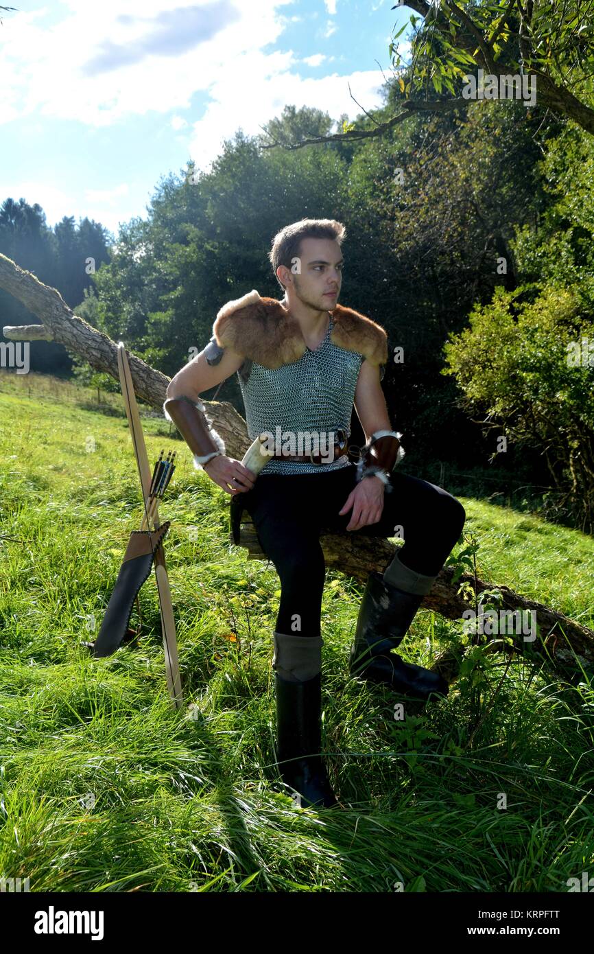 Â medieval archer with chain mail sits on branch in nature Stock Photo ...