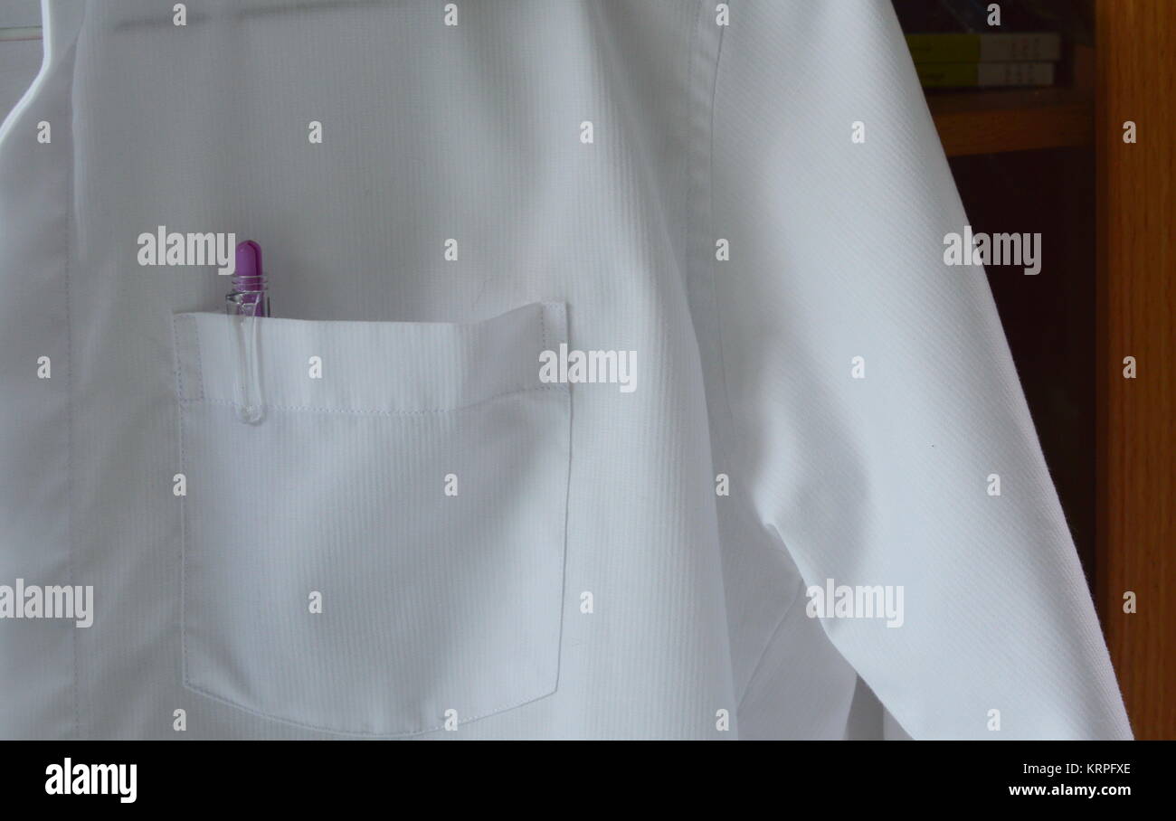 pen stab in white shirt pocket hanging on wall Stock Photo - Alamy