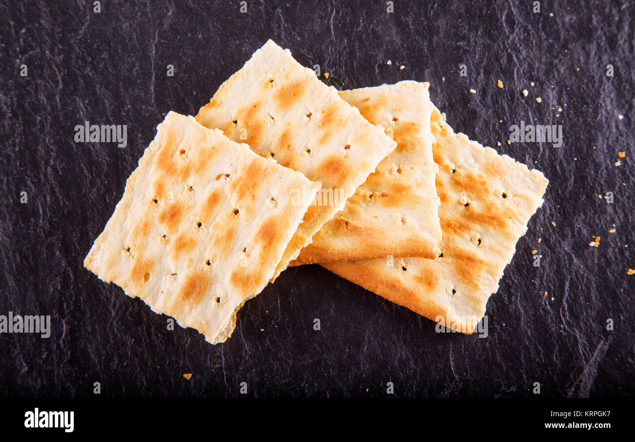 Crackers over black stone background Stock Photo - Alamy