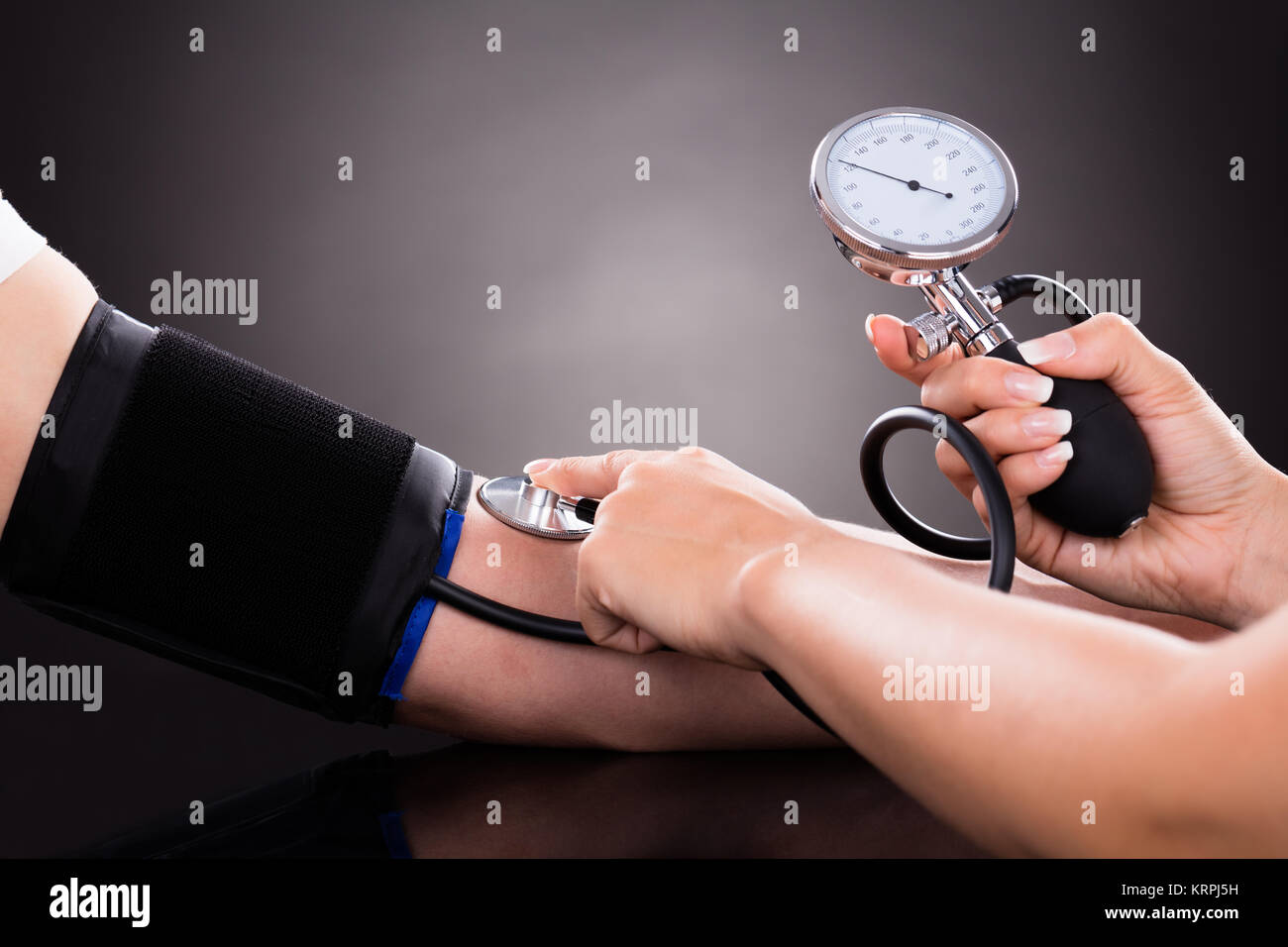 Doctor Checking Blood Pressure Of Patient Stock Photo - Alamy