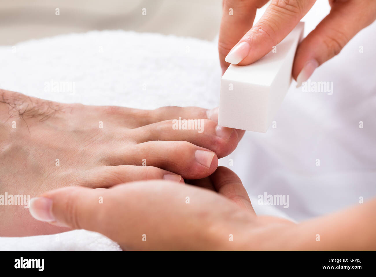 Beautician Hand Filing The Nails Stock Photo - Alamy