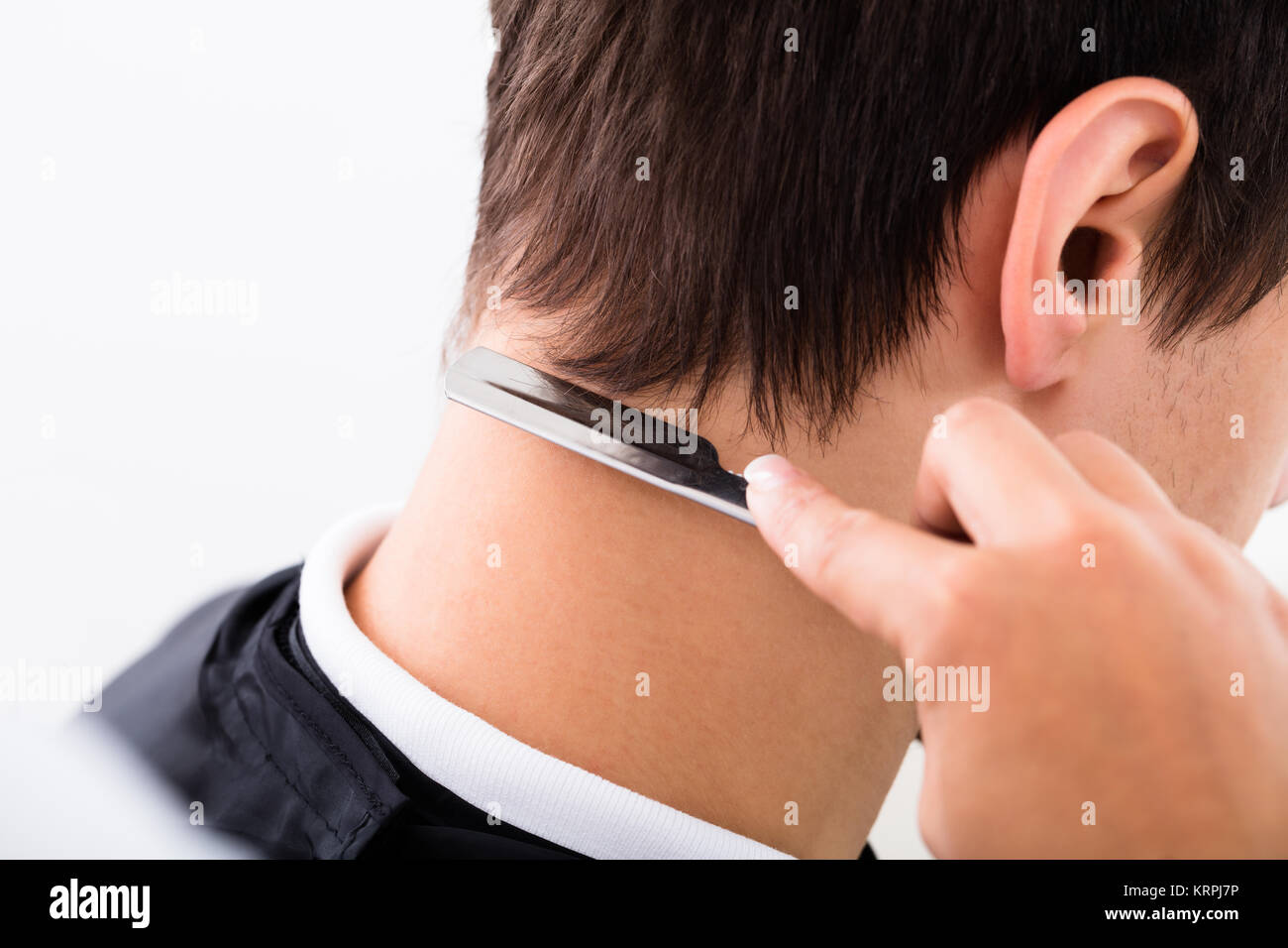 Hairdresser Cutting Man's Hair With Razor Stock Photo - Alamy