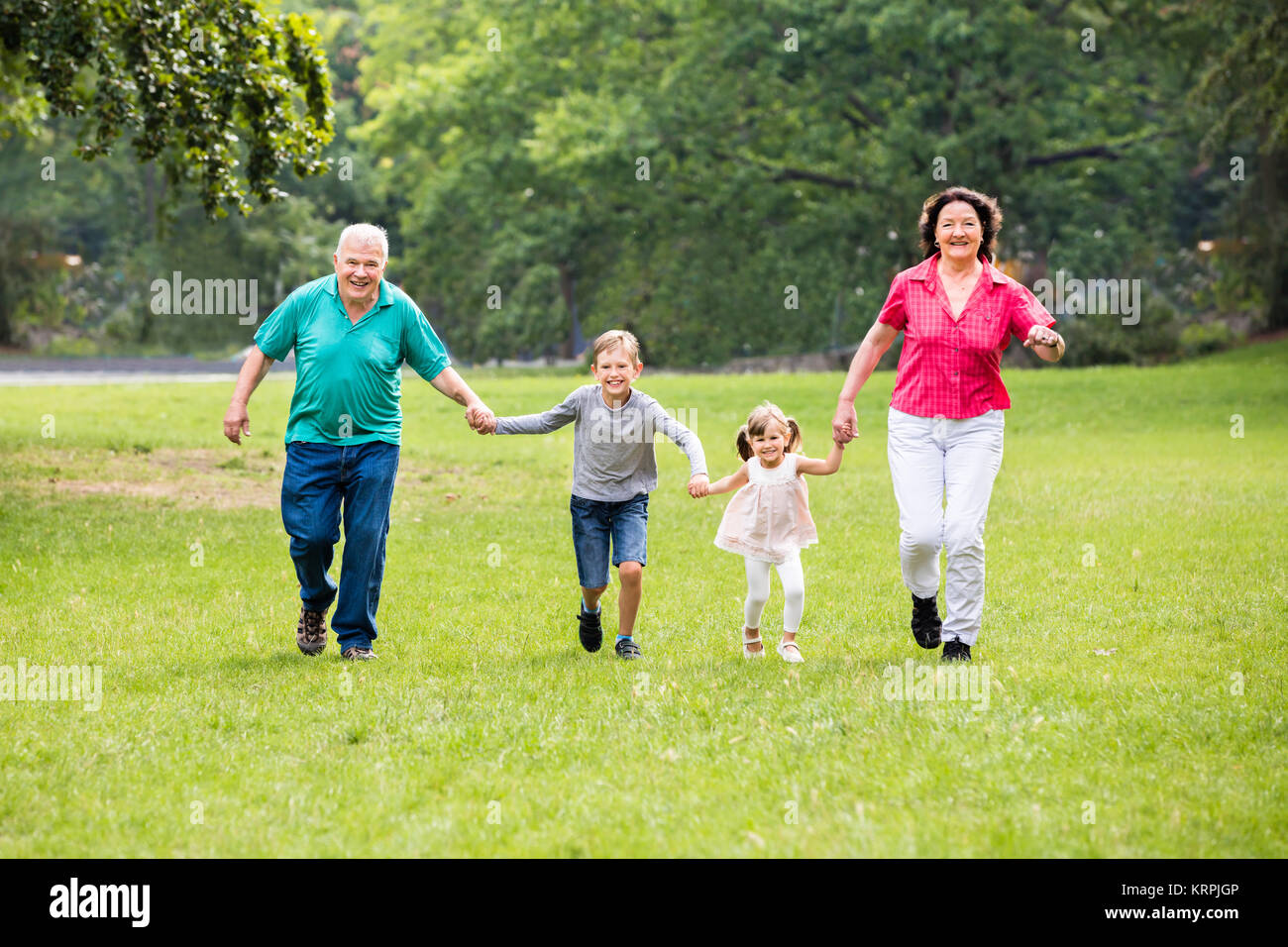 Grandparents And Grandchildren Running In Park Stock Photo - Alamy