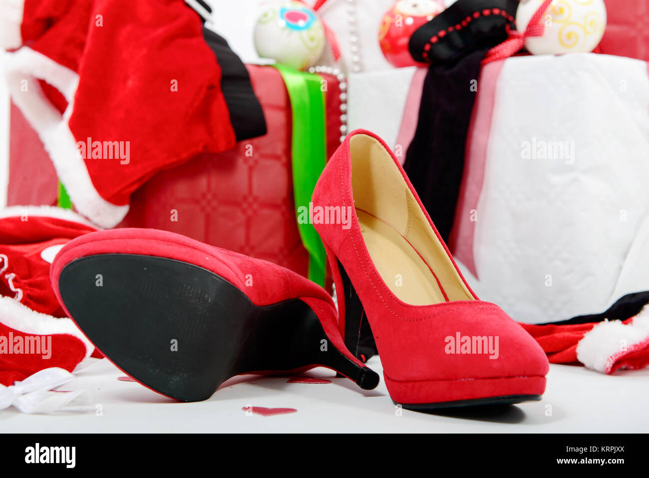 Christmas gift boxes and red woman shoes Stock Photo - Alamy