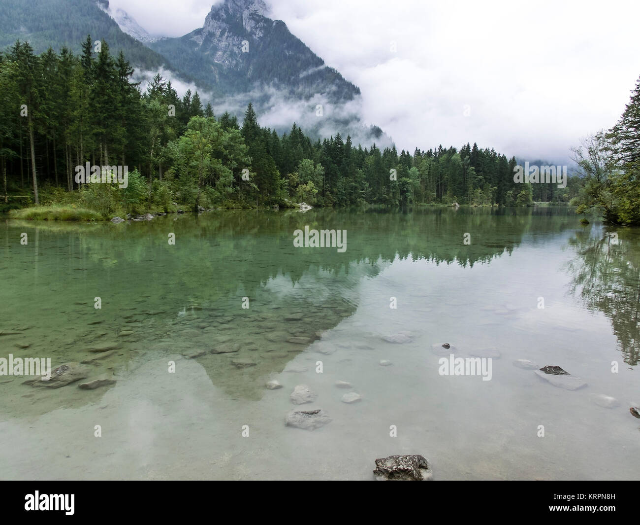 Mountain peaks shrouded in cloud and mist Stock Photo - Alamy