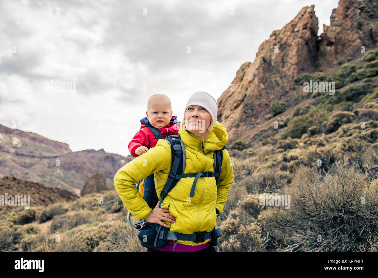 Superhero mother with little boy travelling in backpack. Hiking ...