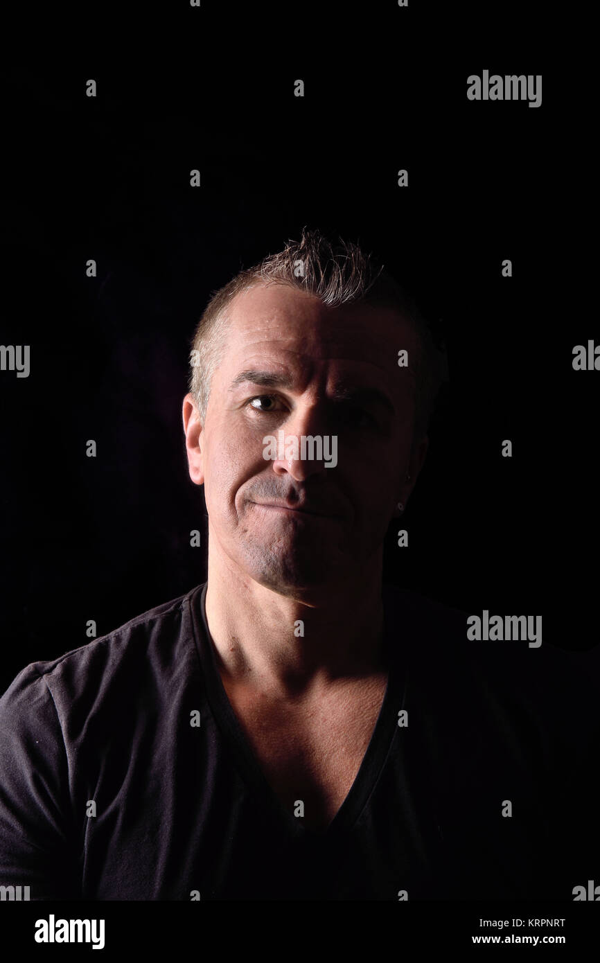 portrait of a man on black background Stock Photo - Alamy