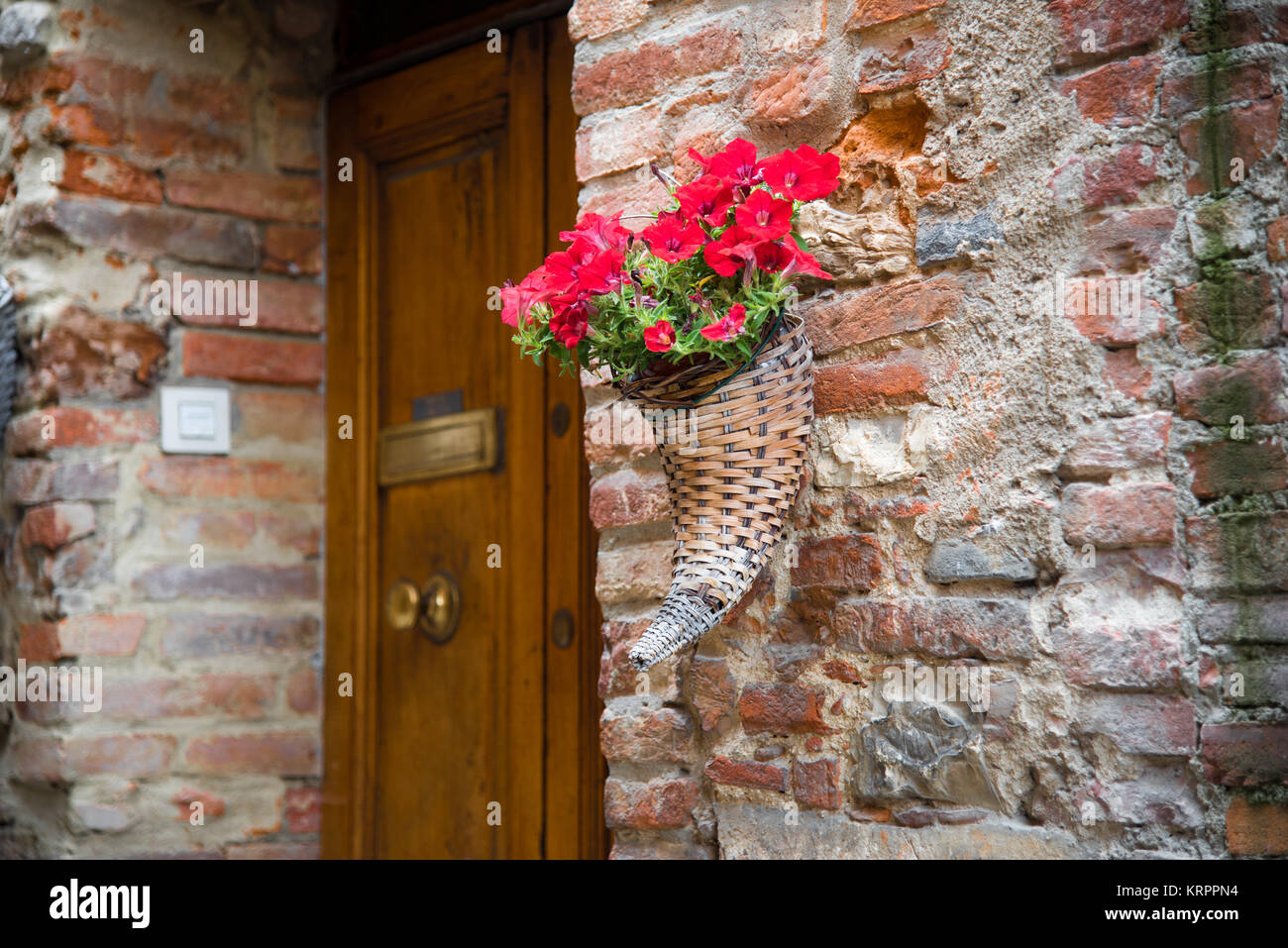 Cornucopia with flowers, somewhere in the medieval town Lucignano in ...