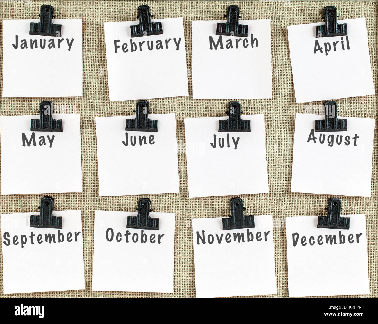Monthly notes clipped on noticeboard Stock Photo - Alamy