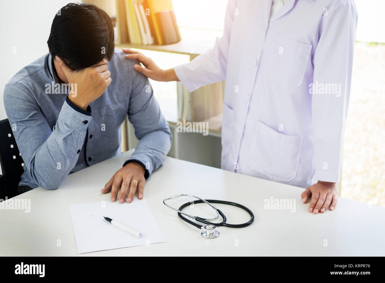 Patient receiving bad news, he is desperate and crying, Doctor support ...