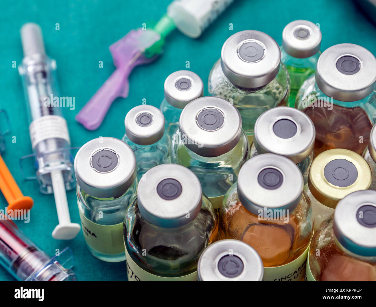 Vials of different size next to syringes at a hospital table ...