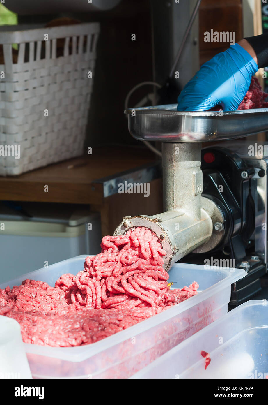 Tray of chopped meat, meat mincer, butcher's hand Stock Photo - Alamy
