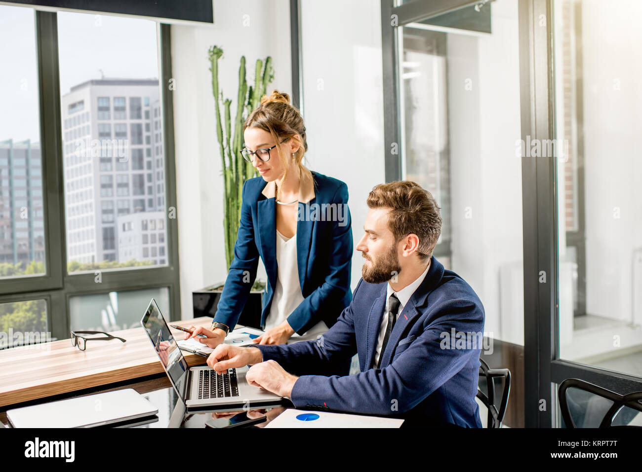 Couple of managers working at the office Stock Photo - Alamy