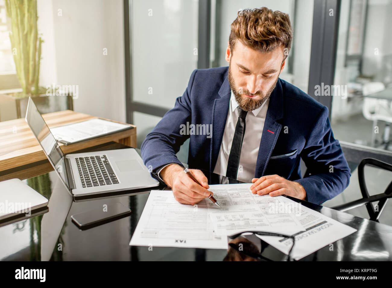Tax manager working at the office Stock Photo - Alamy