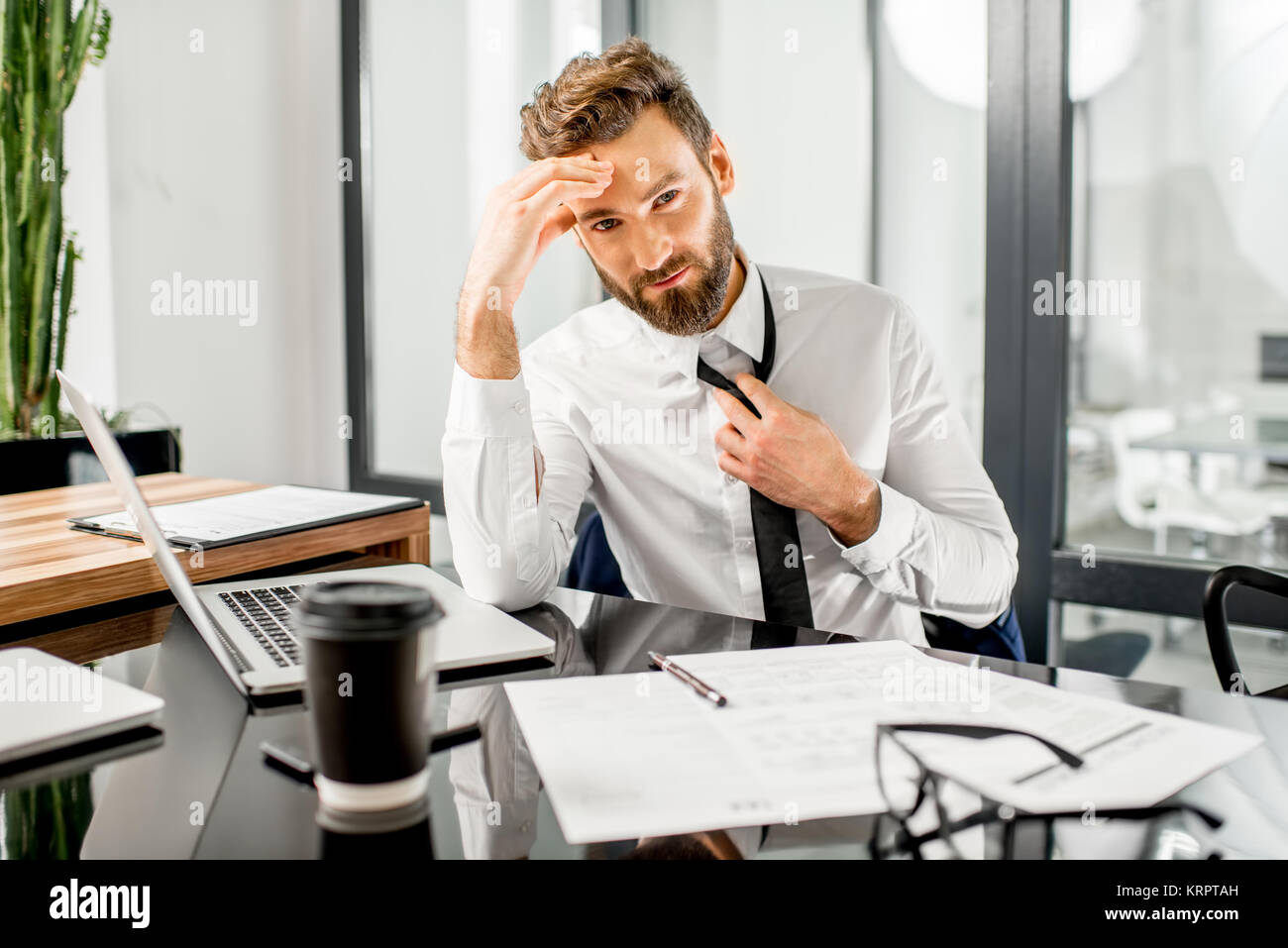 Tired tax manager working at the office Stock Photo - Alamy