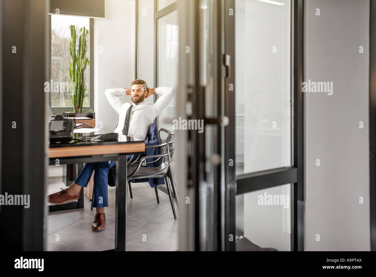 Businessman resting at the office Stock Photo - Alamy