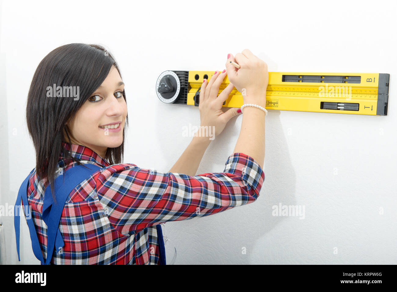 brunette woman using spirit level Stock Photo - Alamy