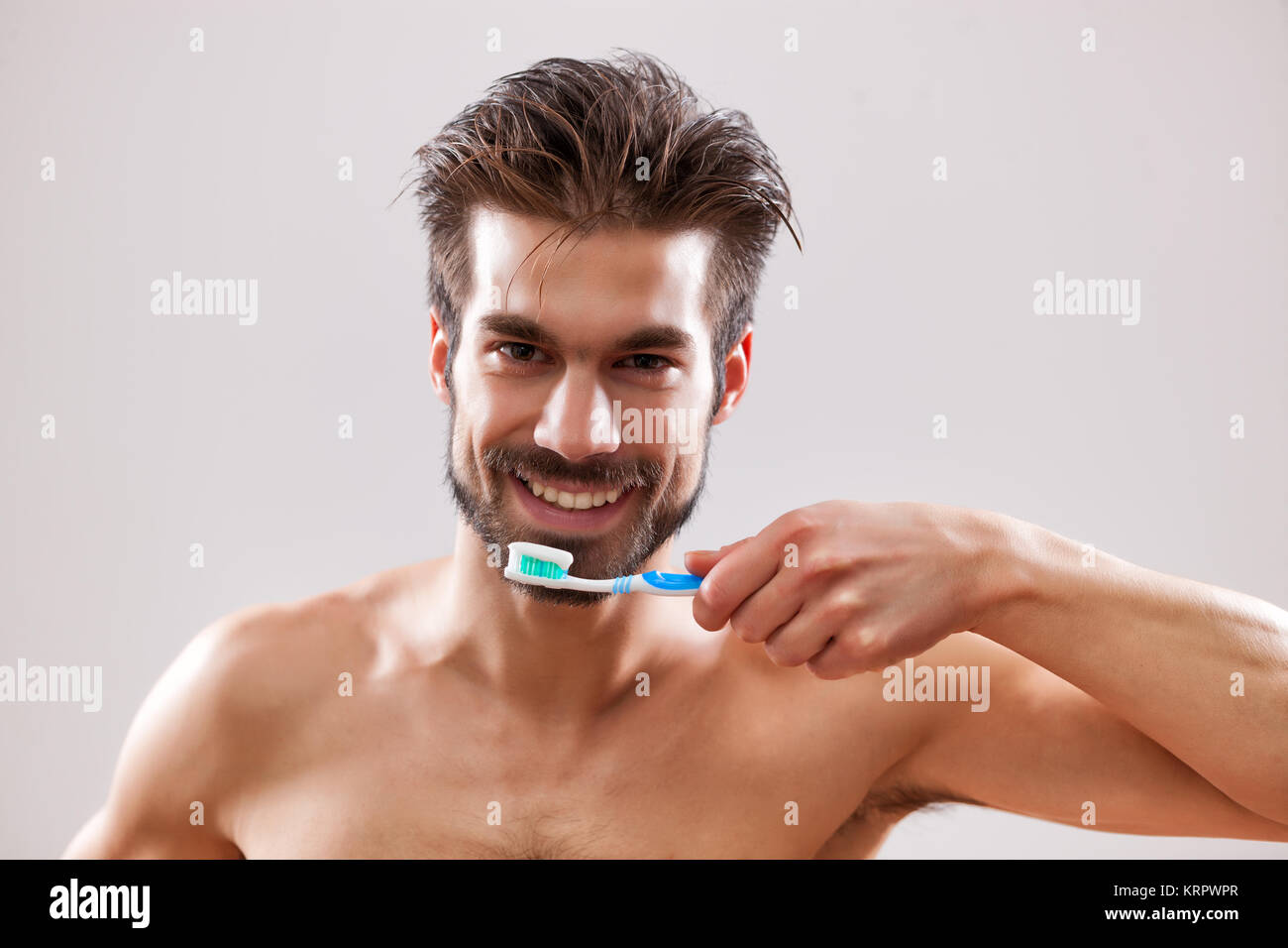 Young handsome man is cleaning his teeth Stock Photo - Alamy