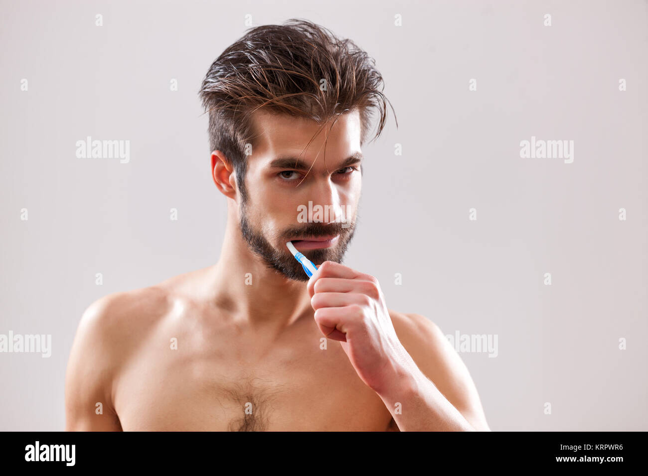Young handsome man is cleaning his teeth Stock Photo - Alamy