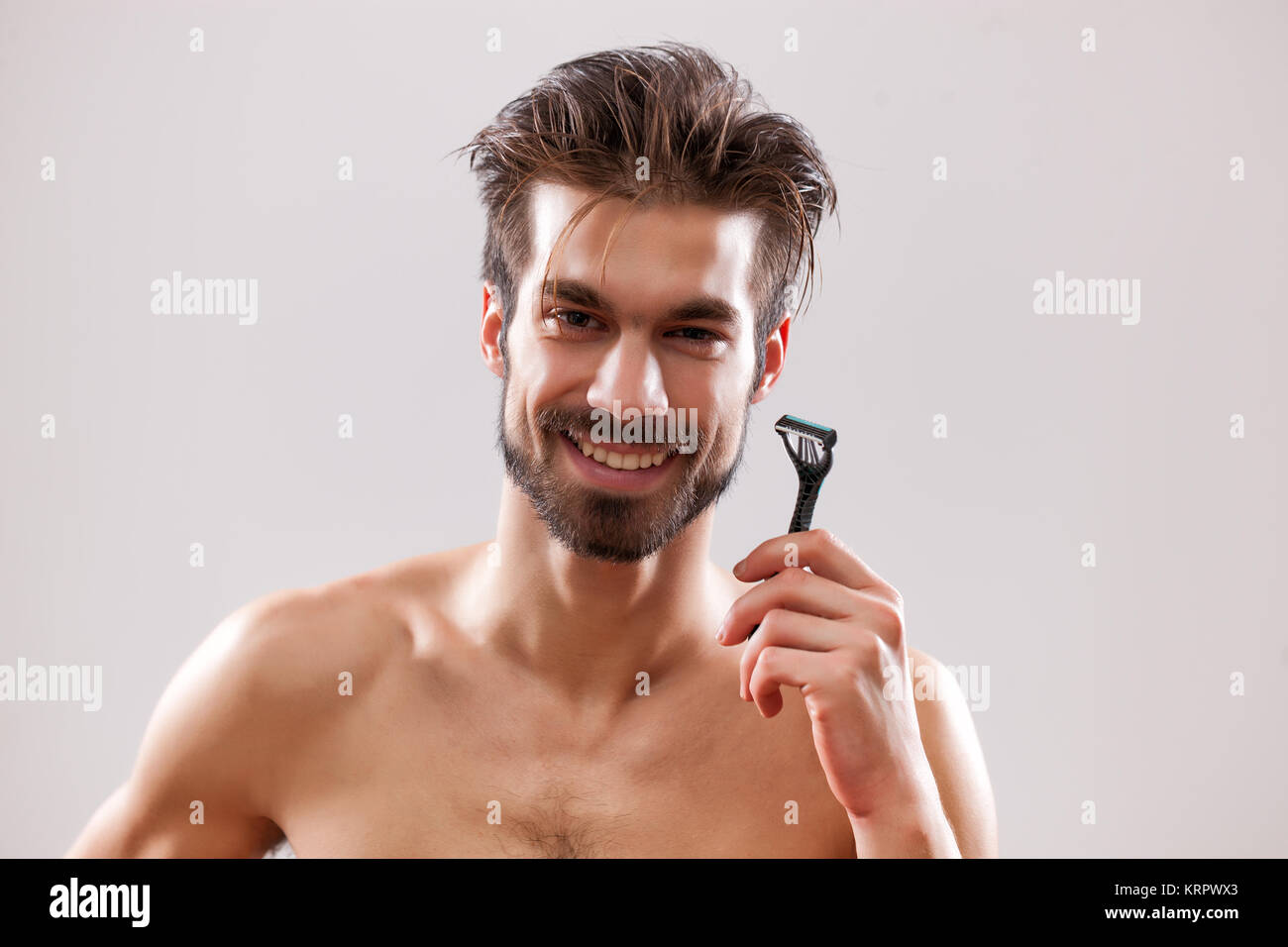 Young man is holding razor and he is going to shave his beard Stock ...