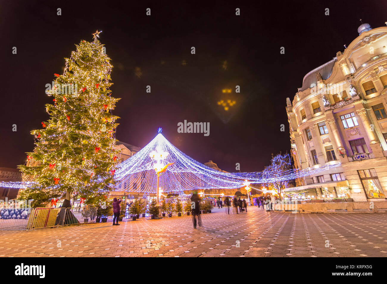 winter night scenery city square with Christmas tree and holiday market ...