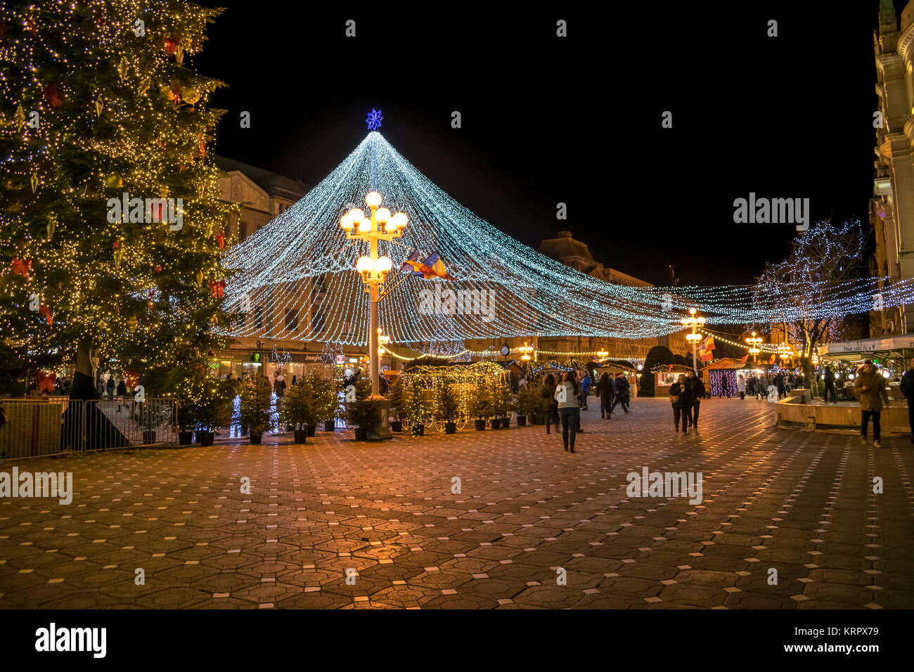 winter night scenery city square with Christmas tree and holiday market ...