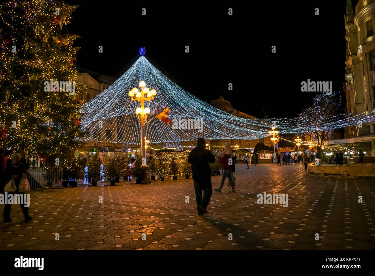 winter night scenery city square with Christmas tree and holiday market ...