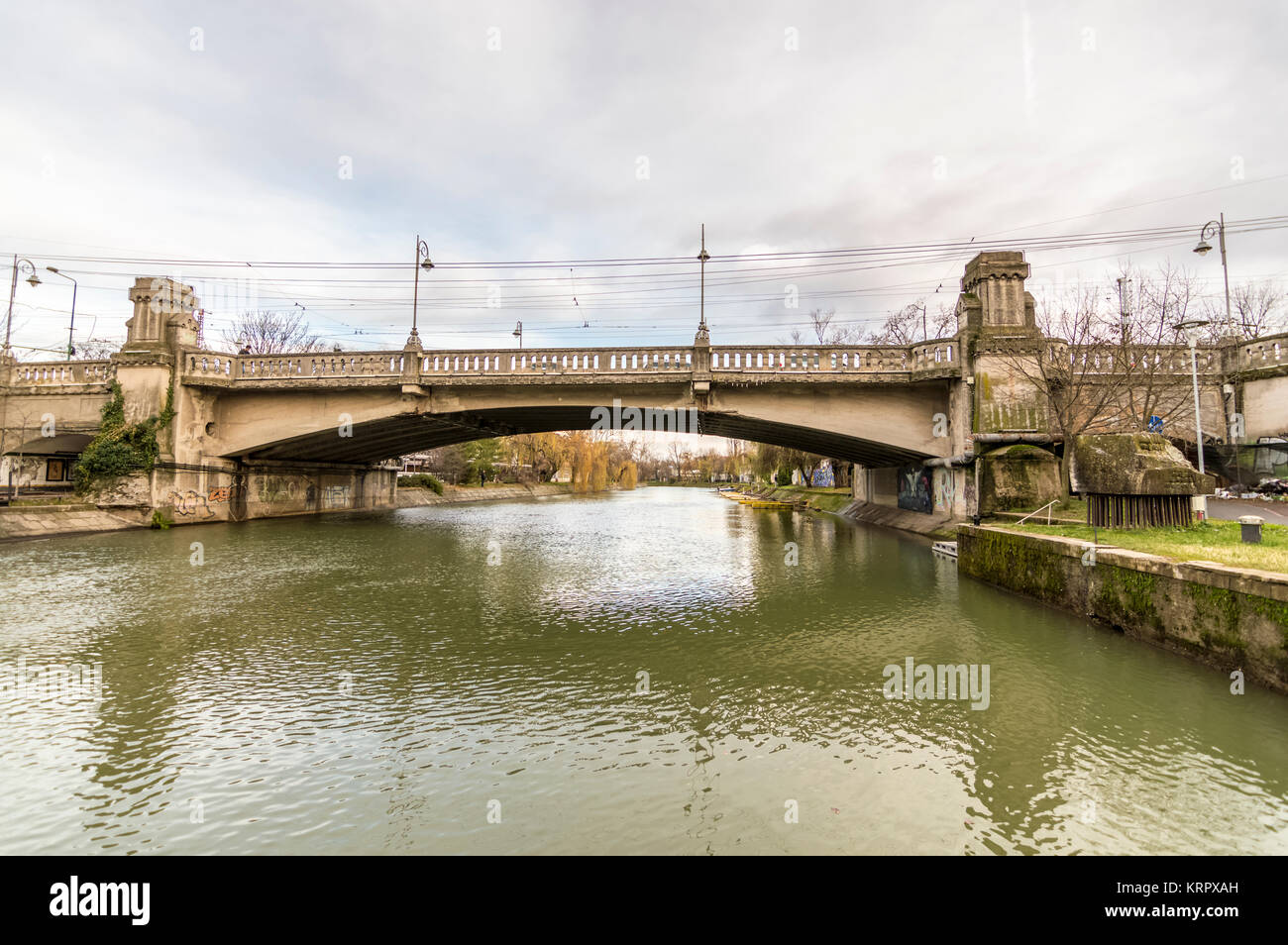 Bega river with arch bridge at sunset. Timisoara city Stock Photo - Alamy
