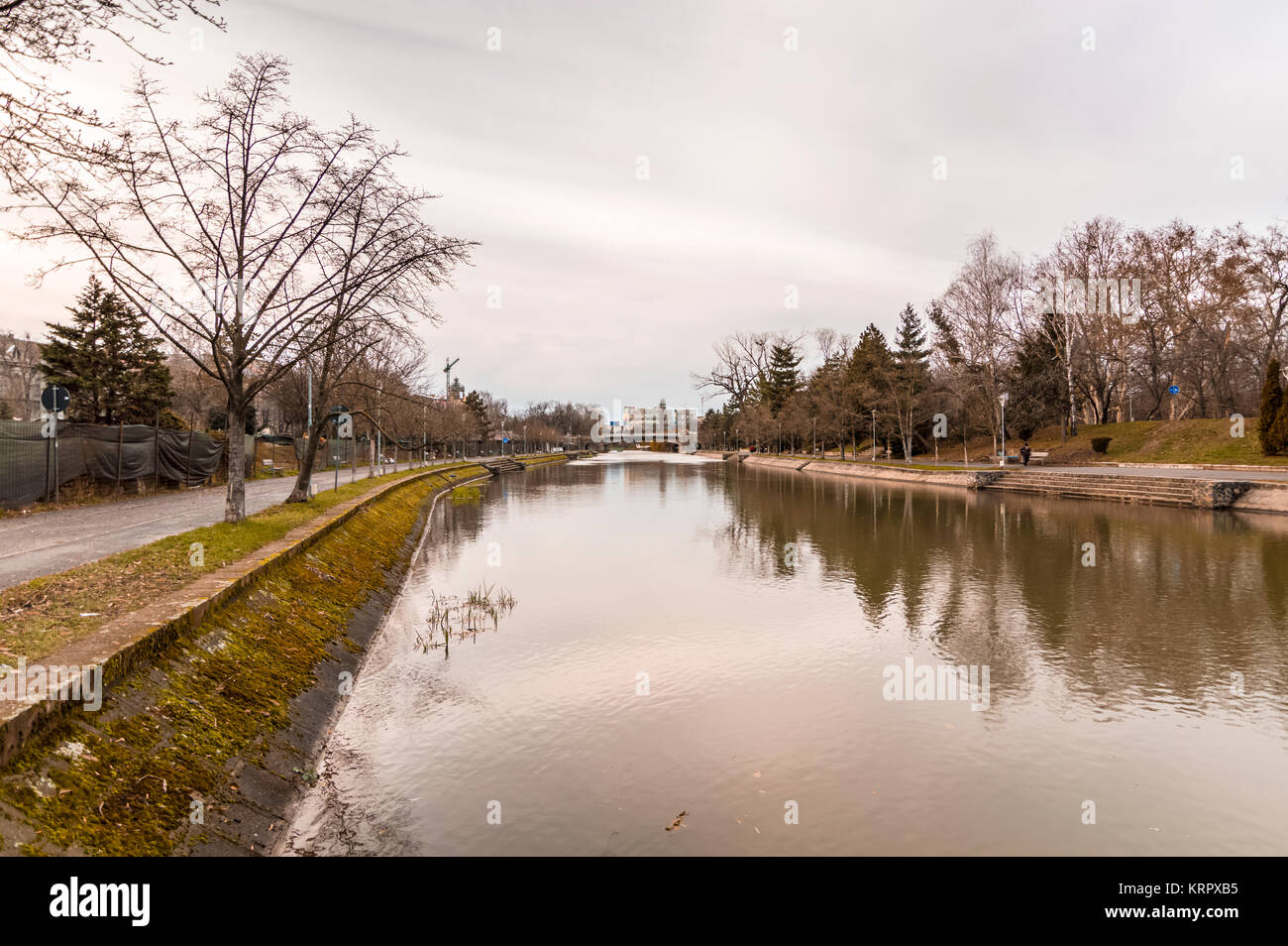Bega river with arch bridge at sunset. Timisoara city Stock Photo - Alamy