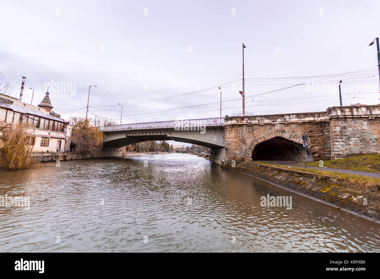 Bega river with arch bridge at sunset. Timisoara city Stock Photo - Alamy