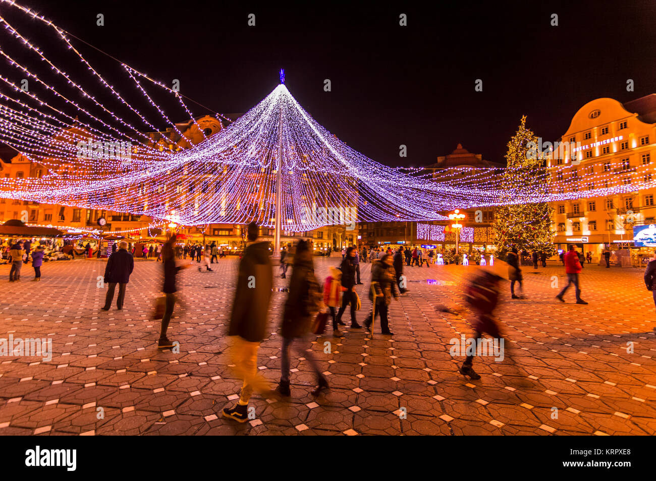 winter night scenery city square with Christmas tree and holiday market ...