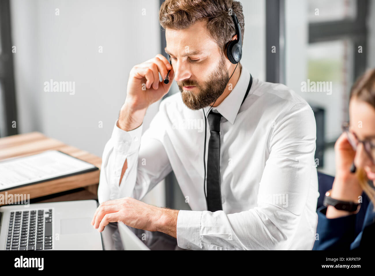 Man working with headset at the office Stock Photo - Alamy