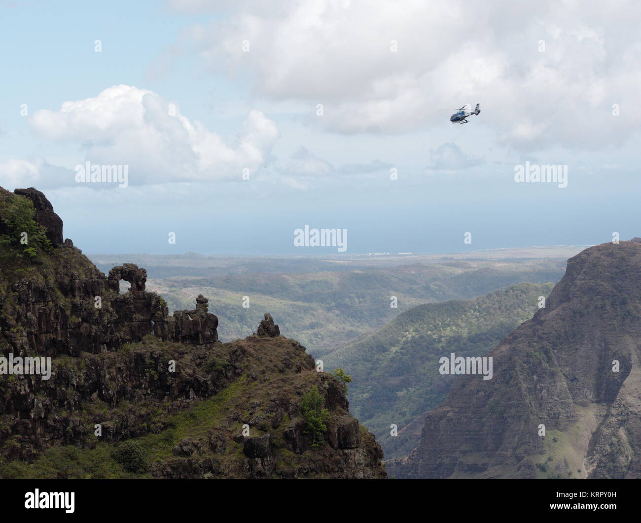Helicopter flying above Waimea canyon rock formations, Kauai, Hawaii ...