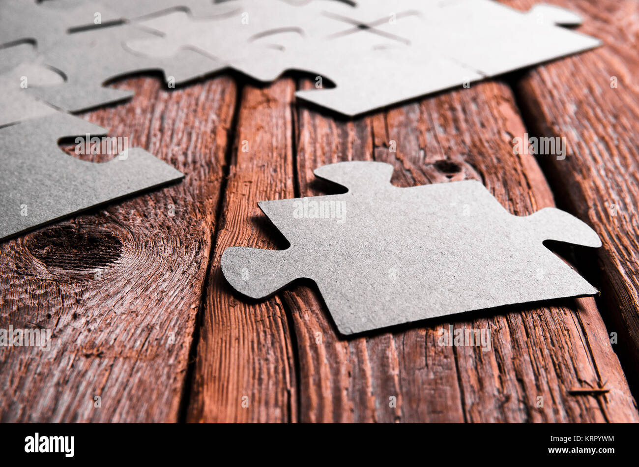 Incomplete puzzles lying on wooden rustic boards Stock Photo - Alamy