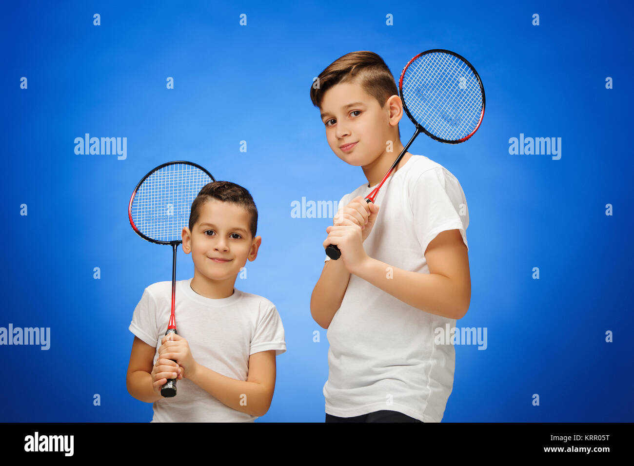The two boys with badminton rackets outdoors Stock Photo - Alamy
