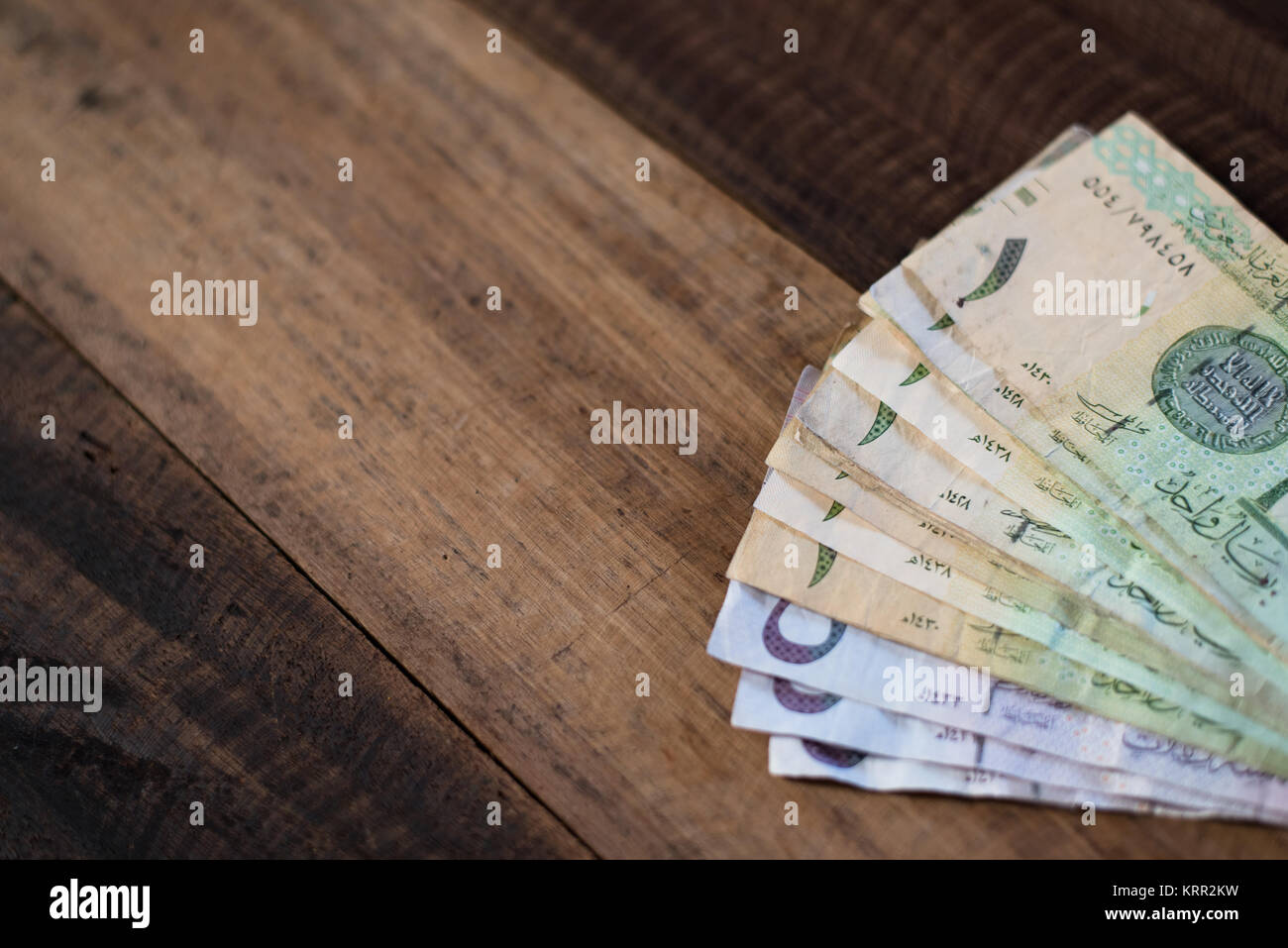 Saudi Riyal Bank notes money on wooden table. financial and currency ...