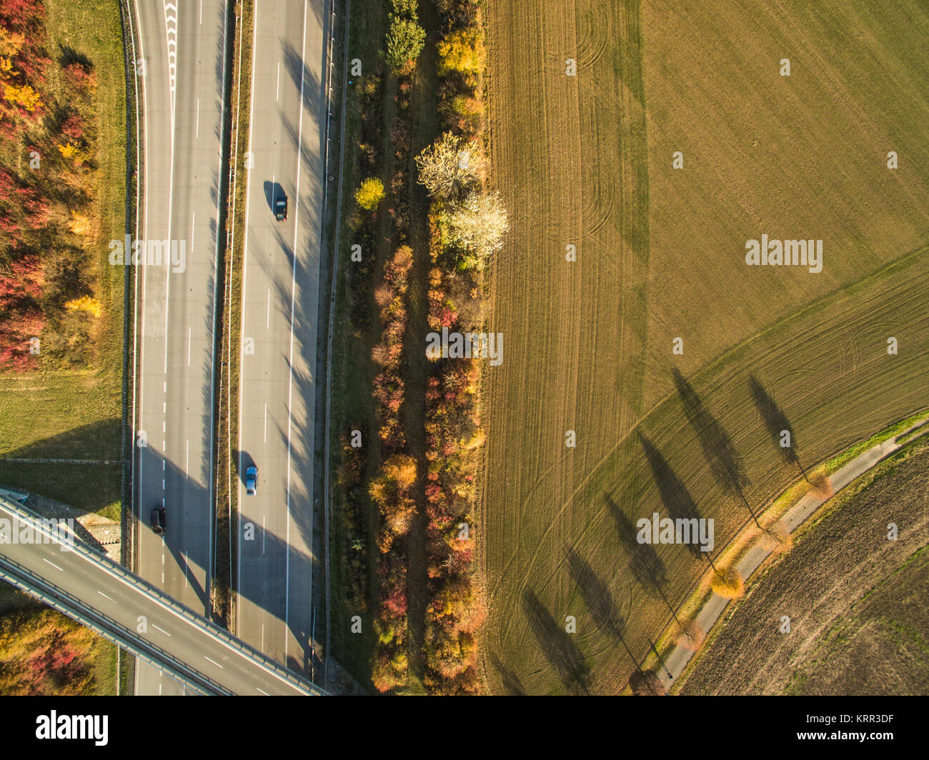 Aerial view of a highway amid fields with cars on it Stock Photo - Alamy