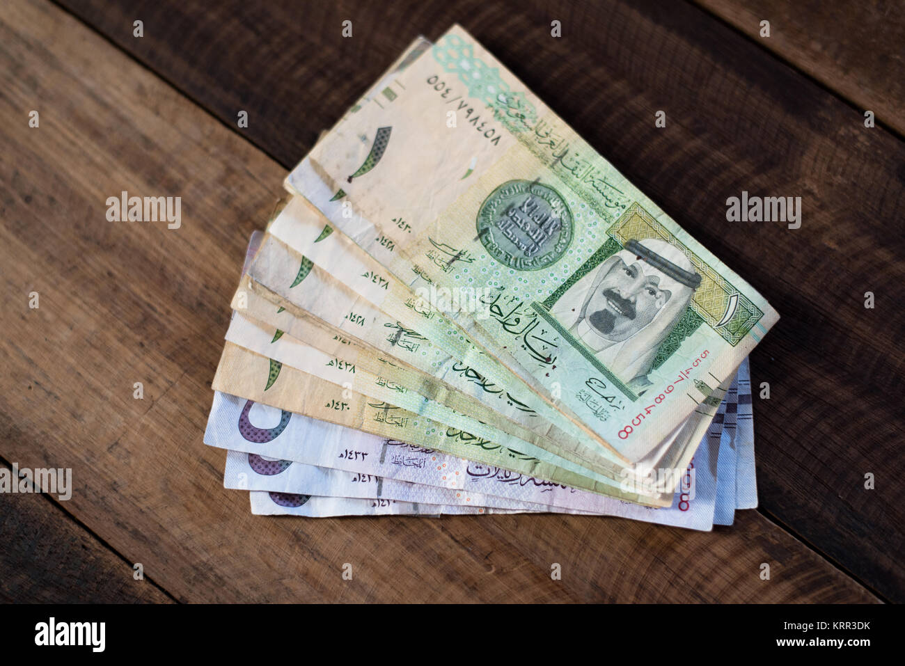 Saudi Riyal Bank notes money on wooden table. financial and currency ...