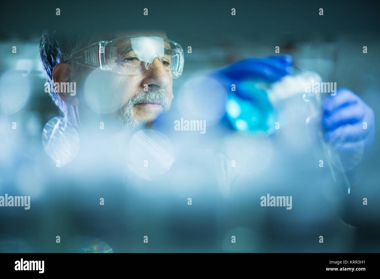 senior male researcher carrying out scientific research in a lab using ...