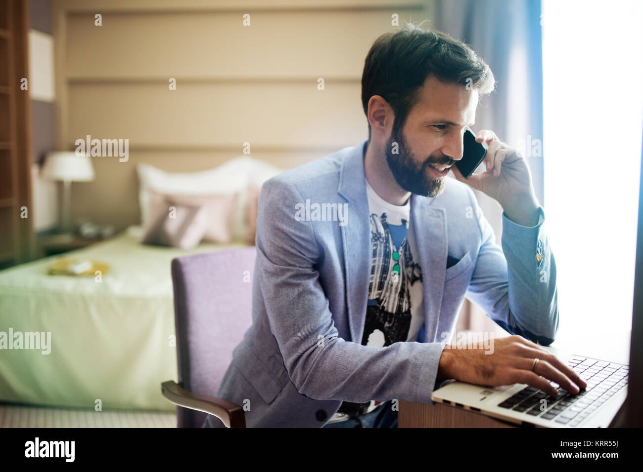 Portrait of successful young handsome man using laptop Stock Photo - Alamy