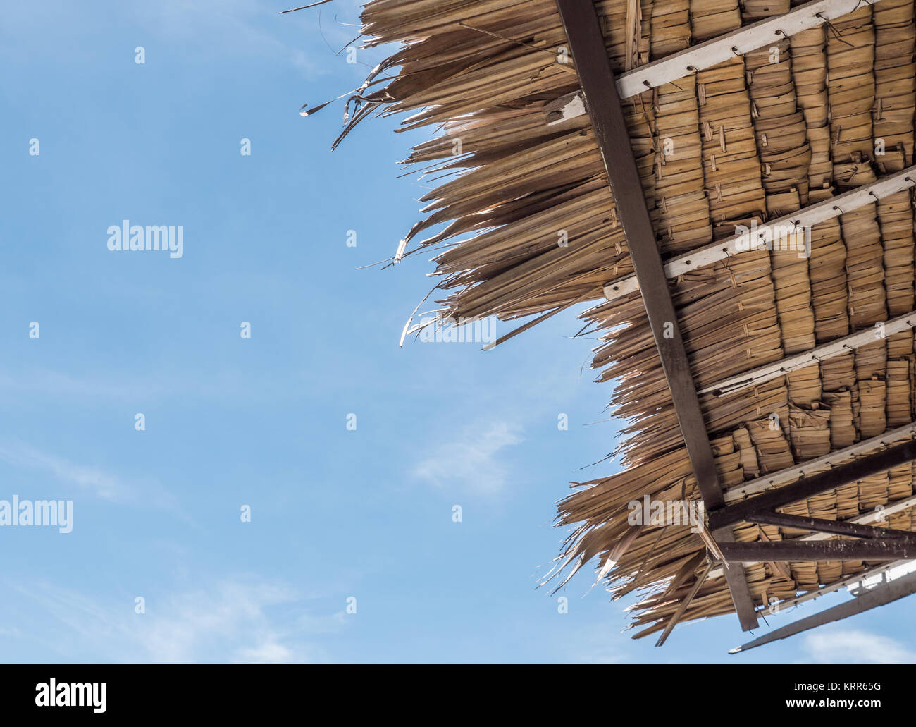 Traditional palm roof with the metal frame of the rural cottage under ...
