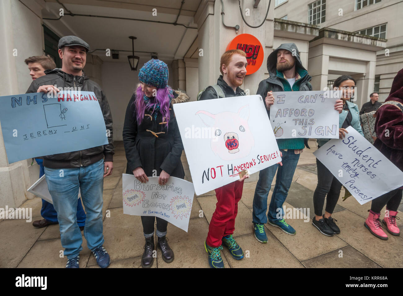People hold hand-drawn posters before the march to save NHS Student ...