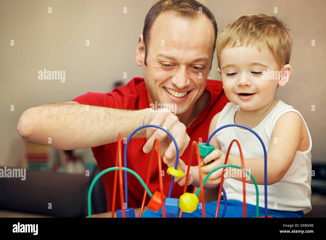 father playing with his child in developing game at home. Dad and son ...