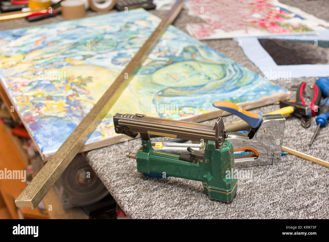 Framing picture in a frame workshop, the working equipment in the ...