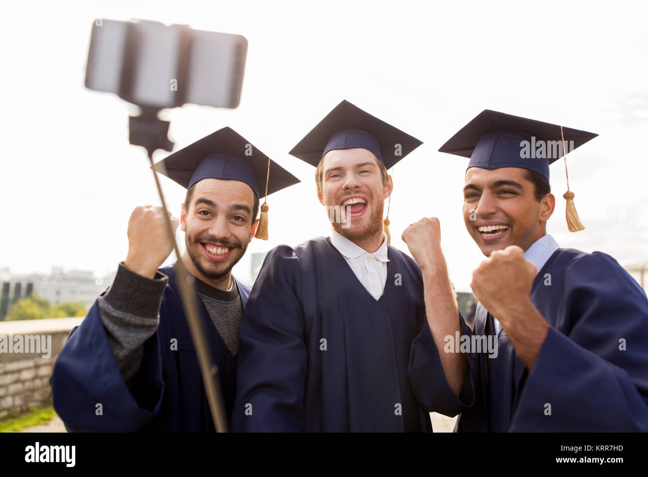 happy male students or graduates taking selfie Stock Photo - Alamy