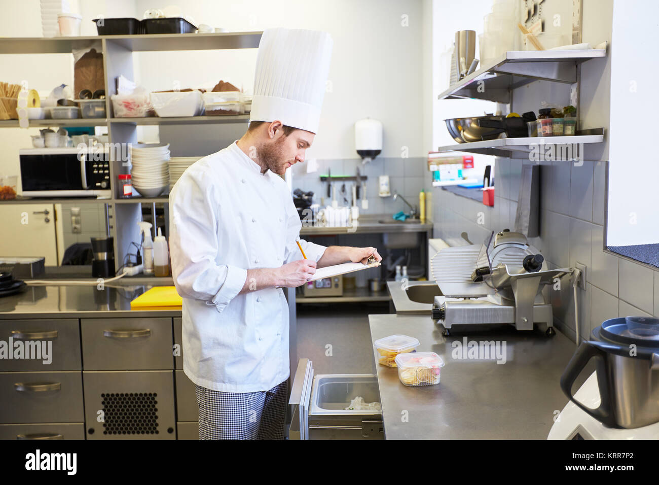 chef with clipboard doing inventory at kitchen Stock Photo - Alamy