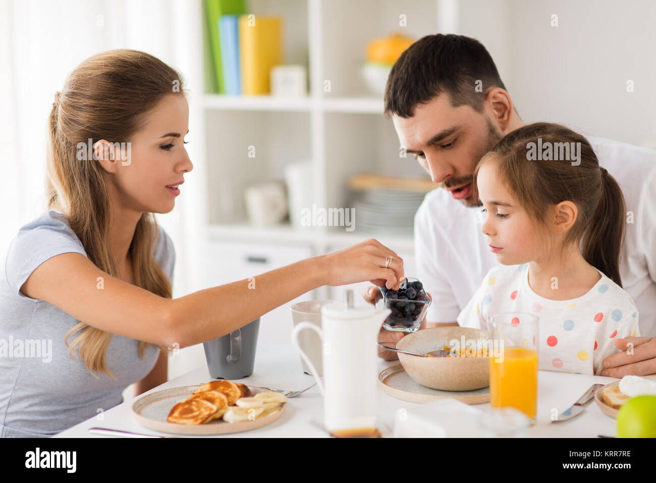 happy family having breakfast at home Stock Photo - Alamy