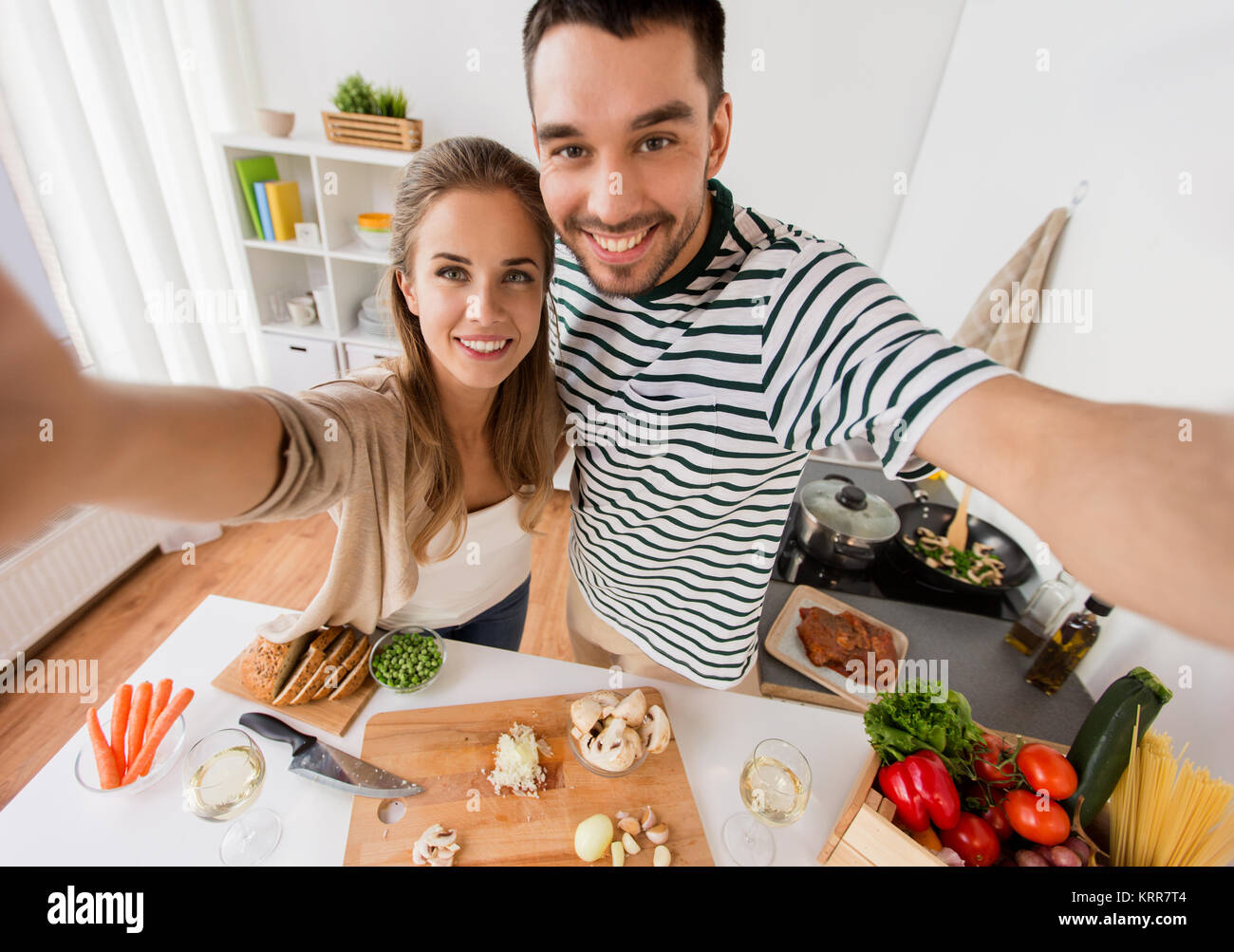 couple cooking food and taking selfie at kitchen Stock Photo - Alamy